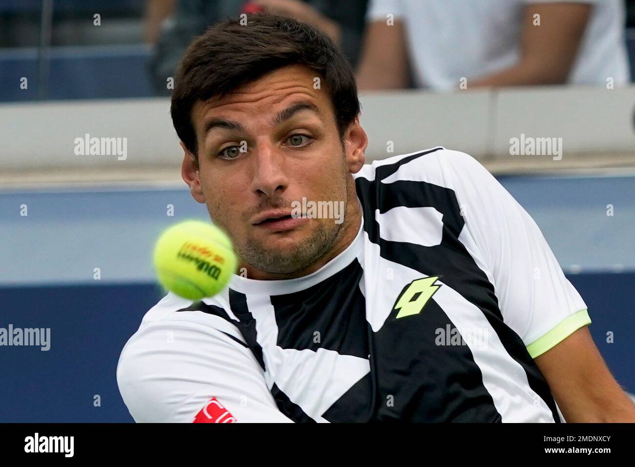 Bernabe Zapata Miralles, of Spain, returns a shot to Felix Auger ...
