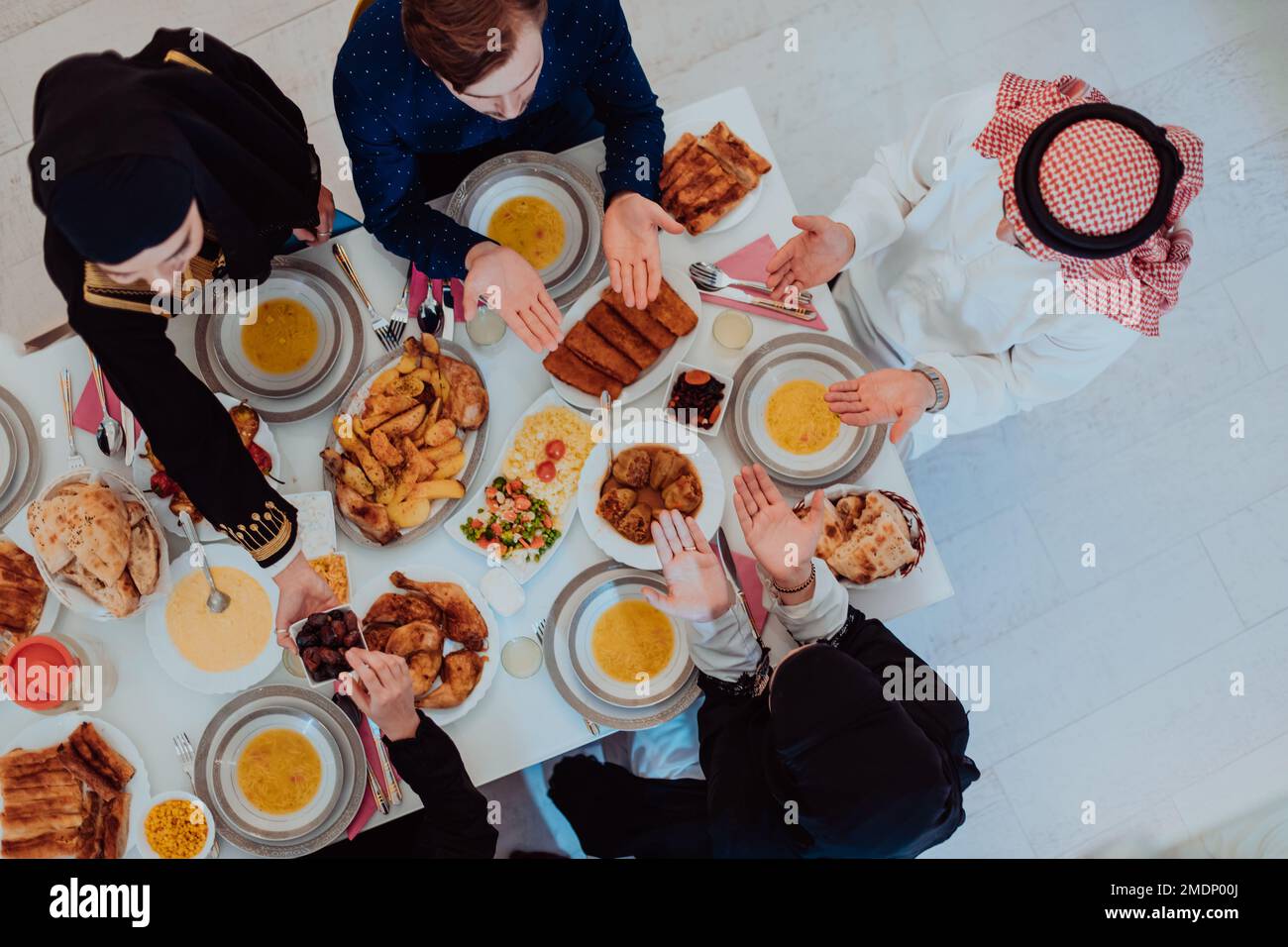 Muslim family having Iftar dinner drinking water to break feast. Eating ...
