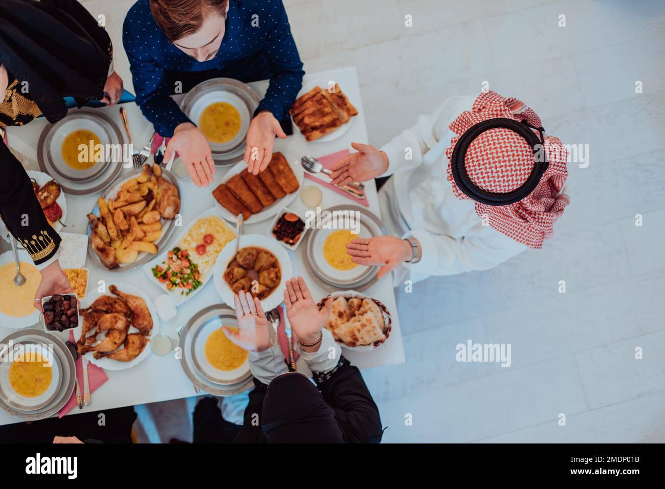 Muslim family having Iftar dinner drinking water to break feast. Eating ...