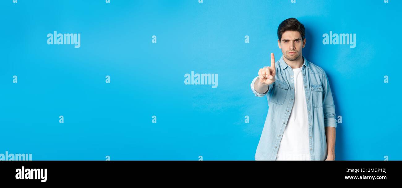 Angry 25 years old man shaking finger in disapproval sign, frowning ...