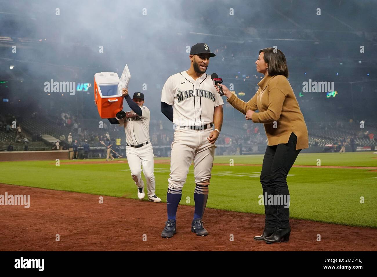 Seattle Mariners' Abraham Toro, center, takes part in an interview with ...