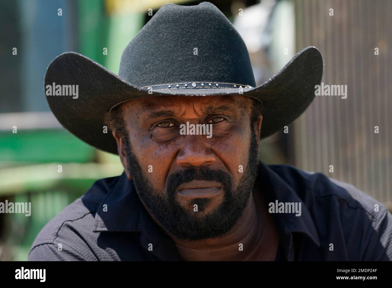 Farmer John Boyd Jr., poses for a portrait before bailing hay at his ...