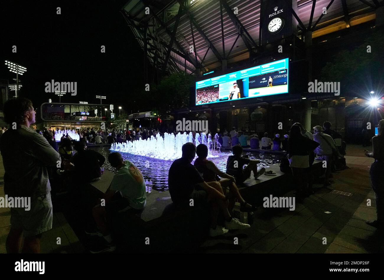 Fans watch tennis action on screens outside Arthur Ashe Stadium at the ...