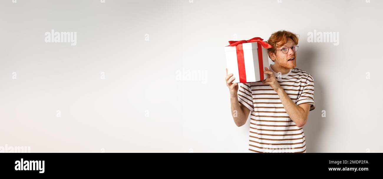 Valentines day and holidays concept. Intrigued young man trying to ...