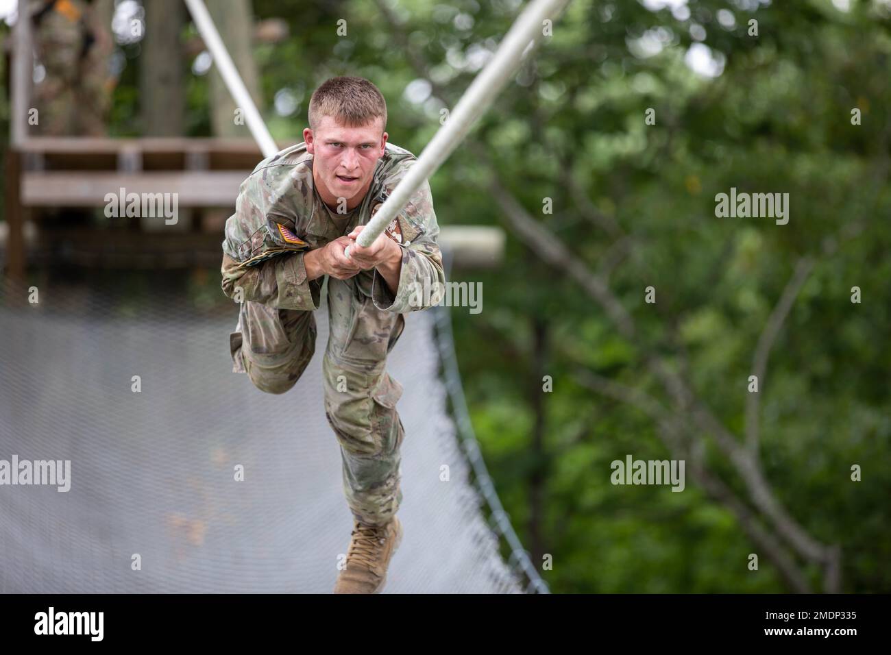 U.S. Army National Guardsman climbs a rope for an obstacle course at ...