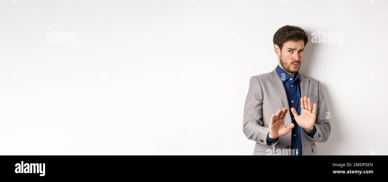 Stay away. Reluctant businessman step back with concerned disgusted ...