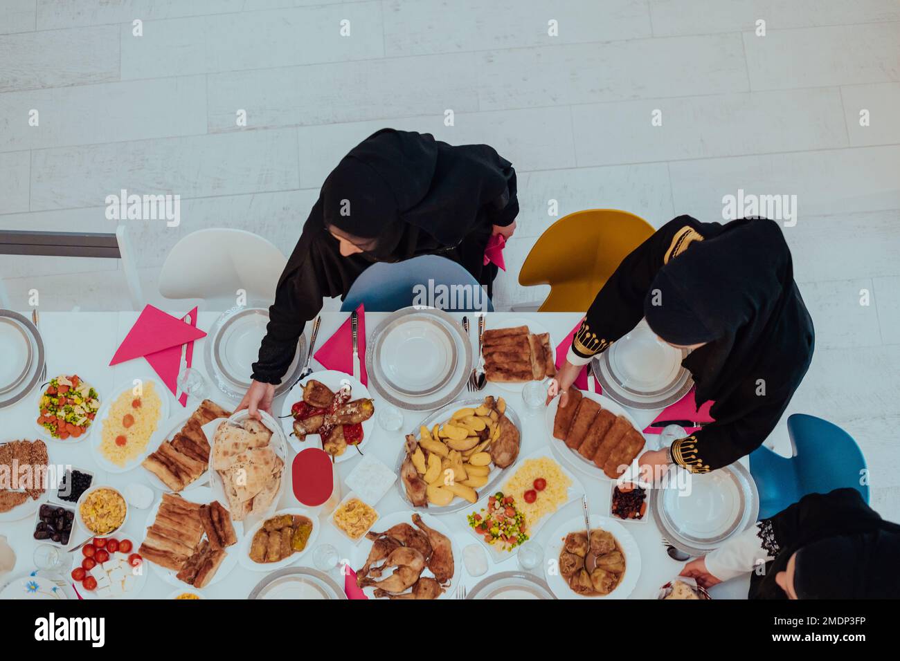 Top view of Muslim family having Iftar dinner drinking water to break ...