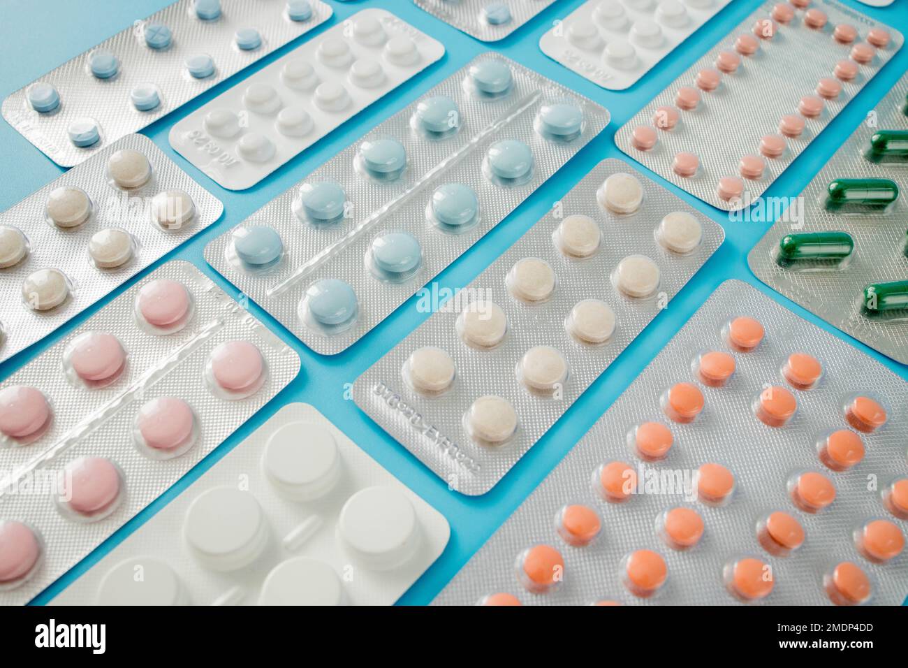Pharmaceutical drugs, antibiotics, pills. Colorful pills on a blue ...