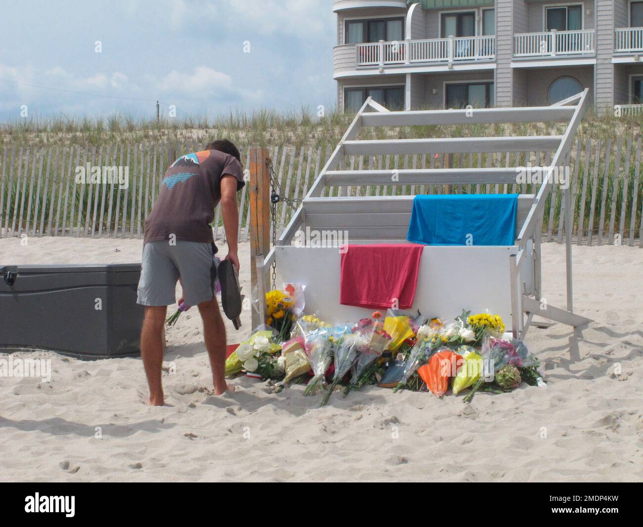 Michael Cordiano, a lifeguard in Berkeley Township, N.J., lays flowers ...