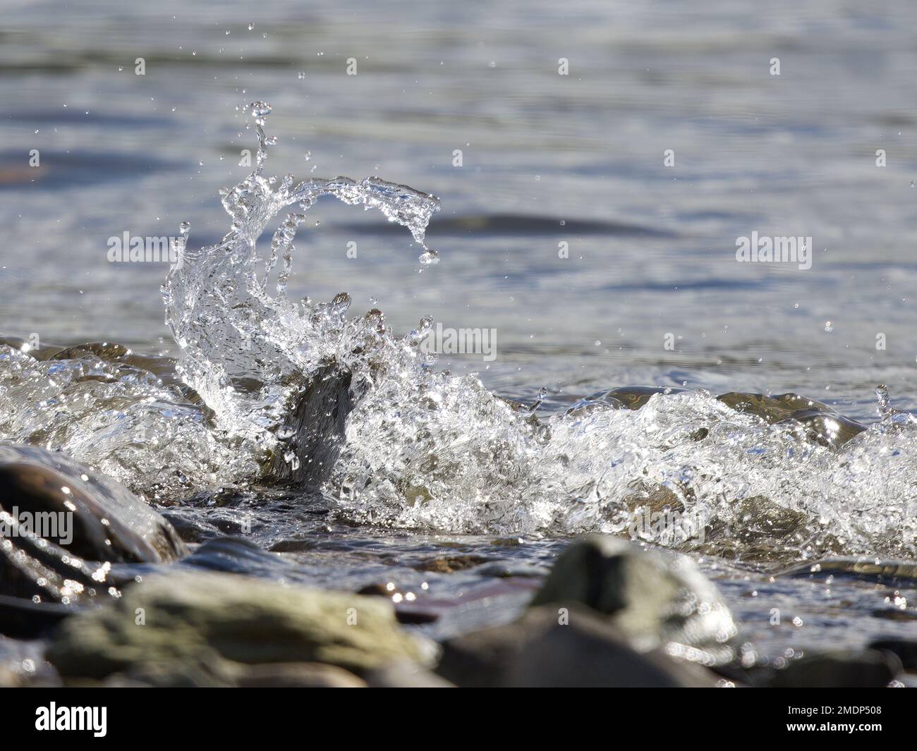 A selective focus shot of water splashing on the coastal stone Stock ...