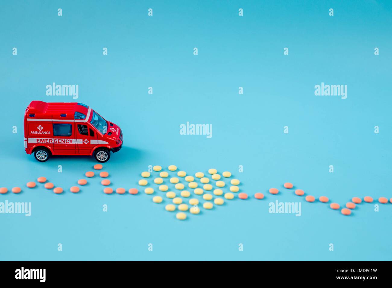 Drawing of a cardiogram from pills on a blue background and ambulance ...