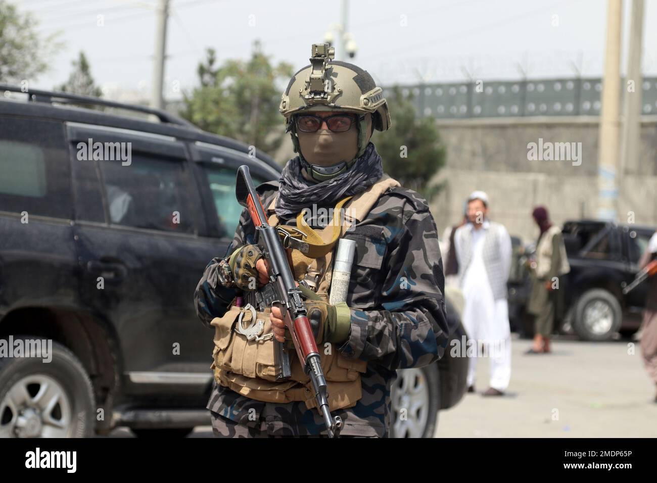 Taliban special forces fighters stand guard outside the Hamid Karzai ...
