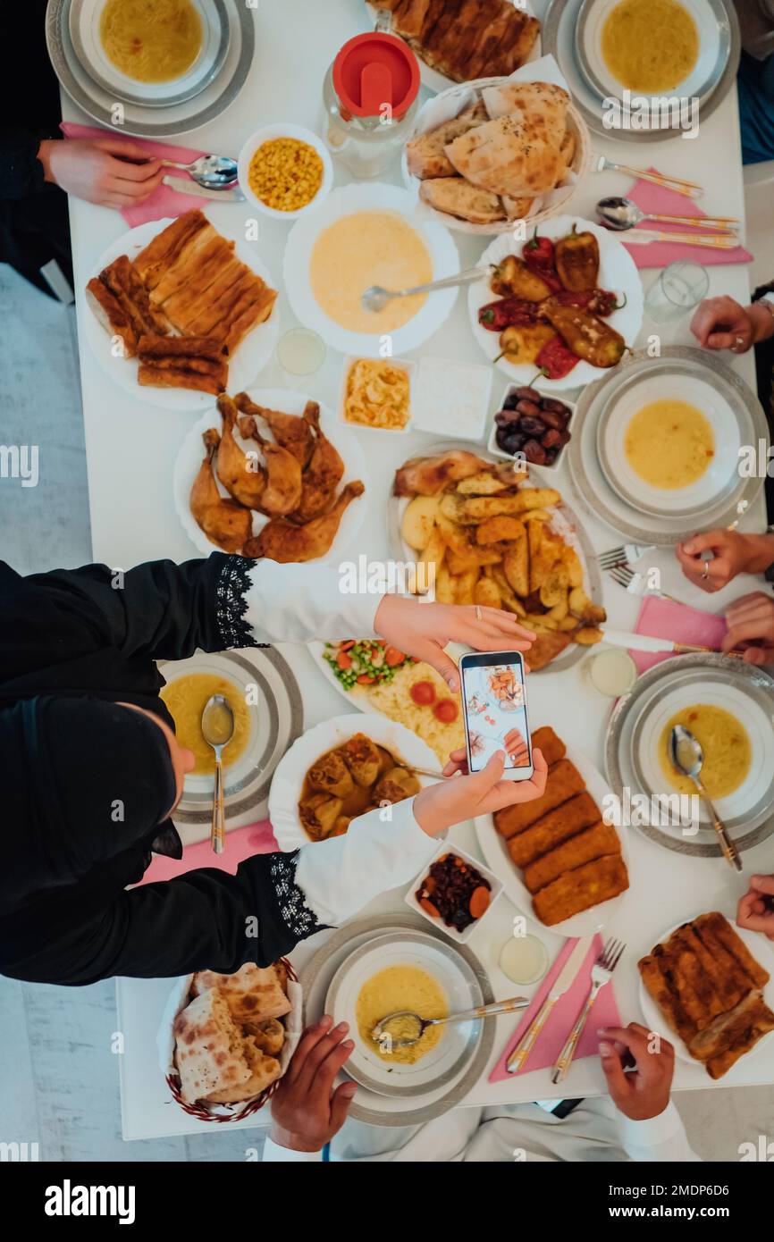 Top view of Muslim family having Iftar dinner drinking water to break ...