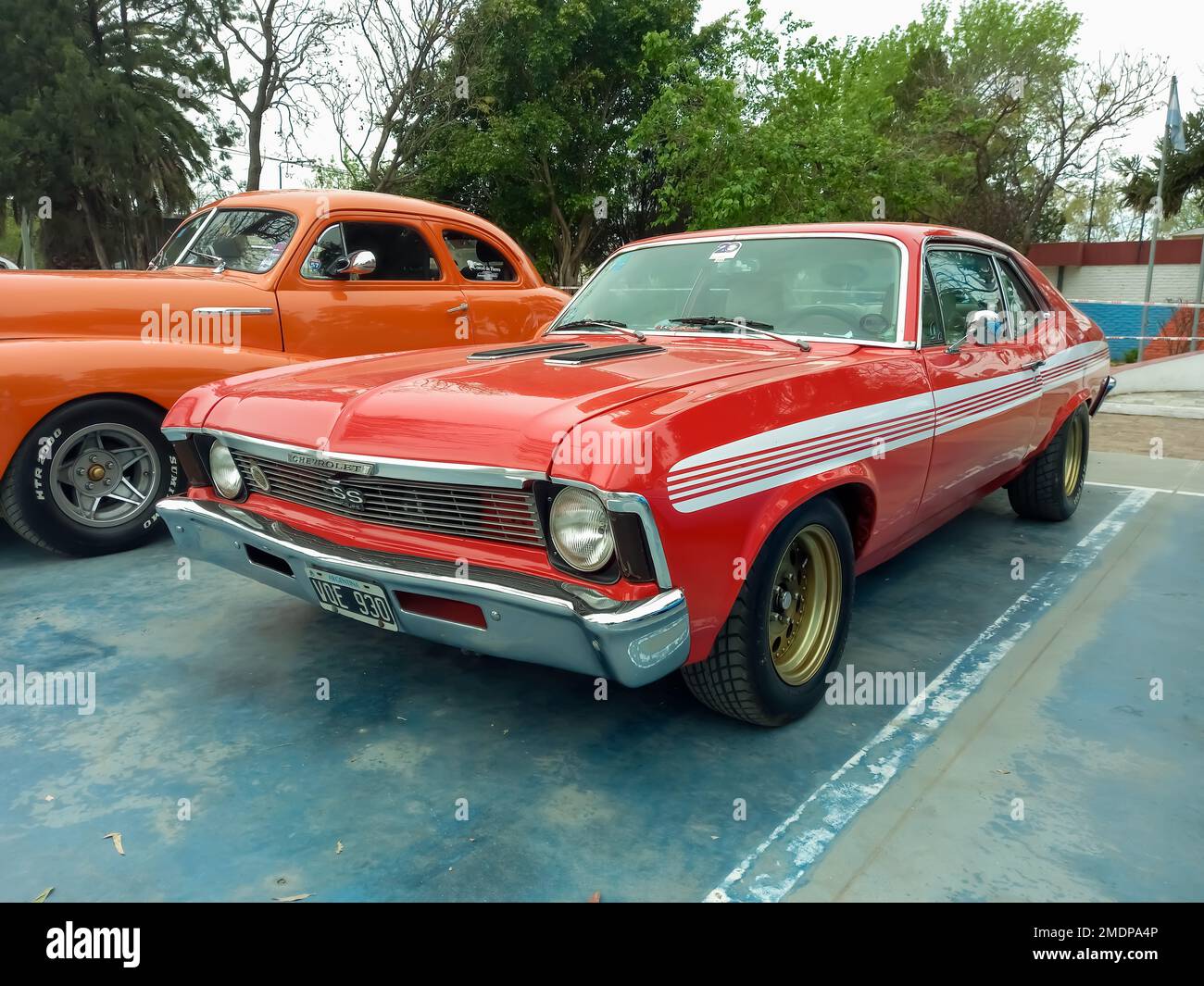Old red sporty 1970s Chevrolet Chevy SS coupe by GM Argentina in a park ...