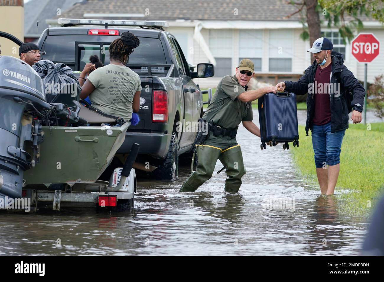 Rescue personnel help residents of the Spring Meadow subdivision out of ...