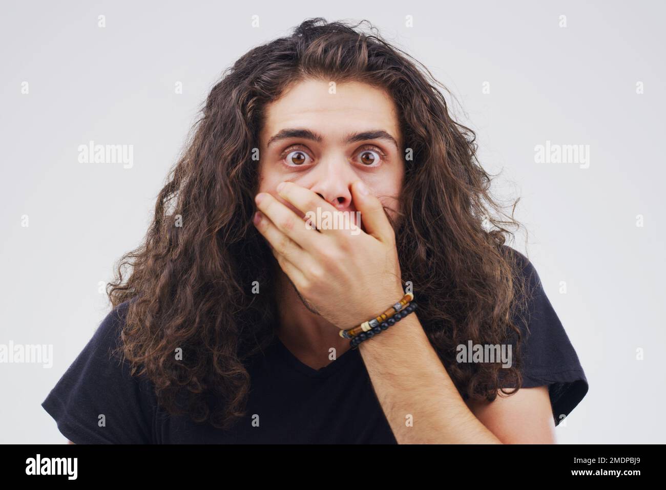 Wait, whaaaat. Studio shot of a young man looking shocked against a ...
