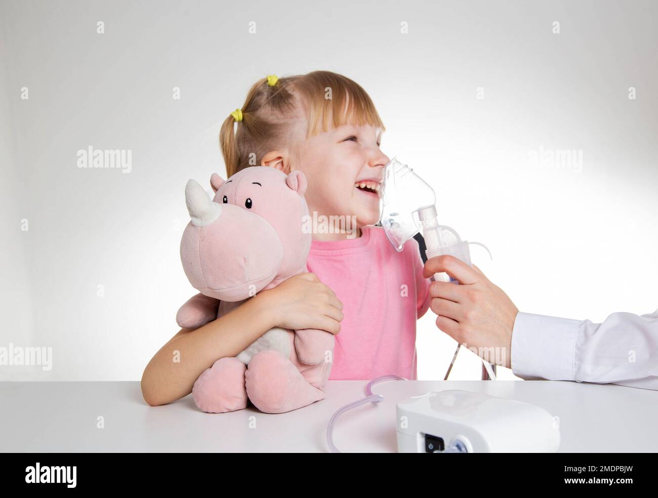 A 5-year-old girl breathes into an inhaler to dilute sputum in case of ...