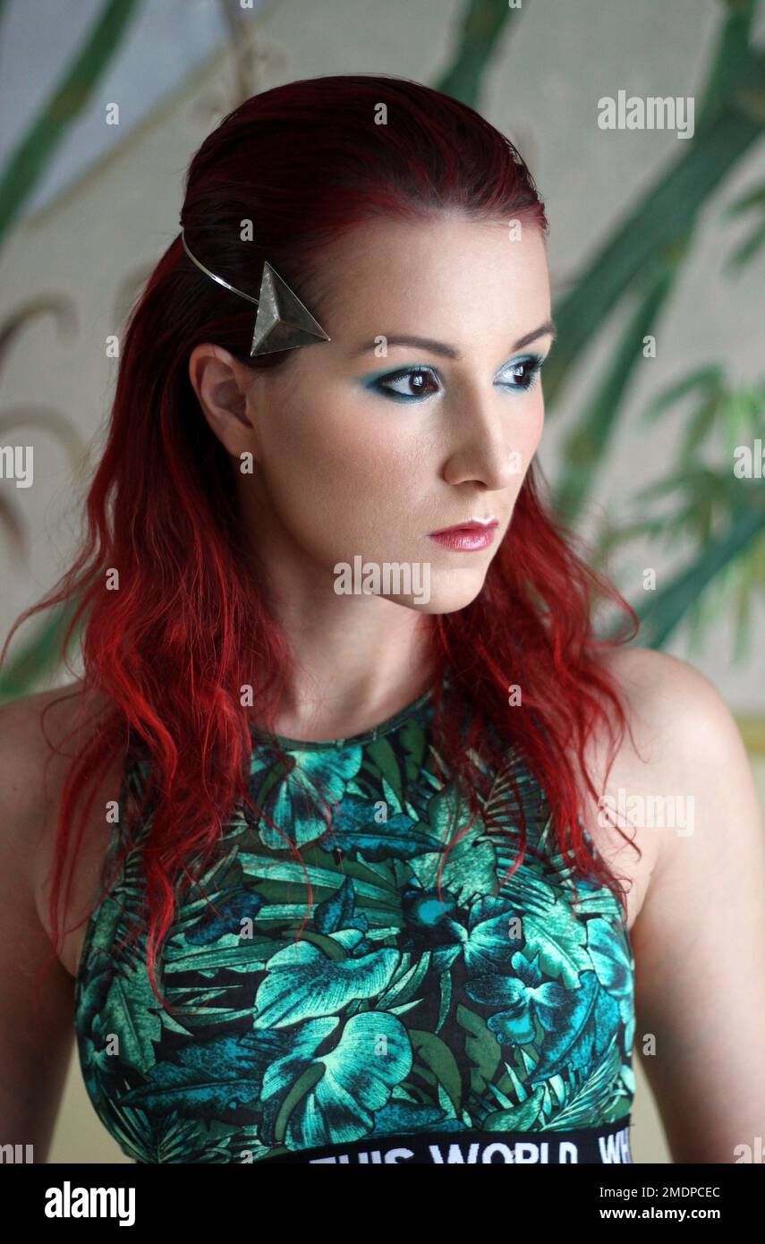 Redhead young woman in bright green top and silver tiara portrait Stock ...