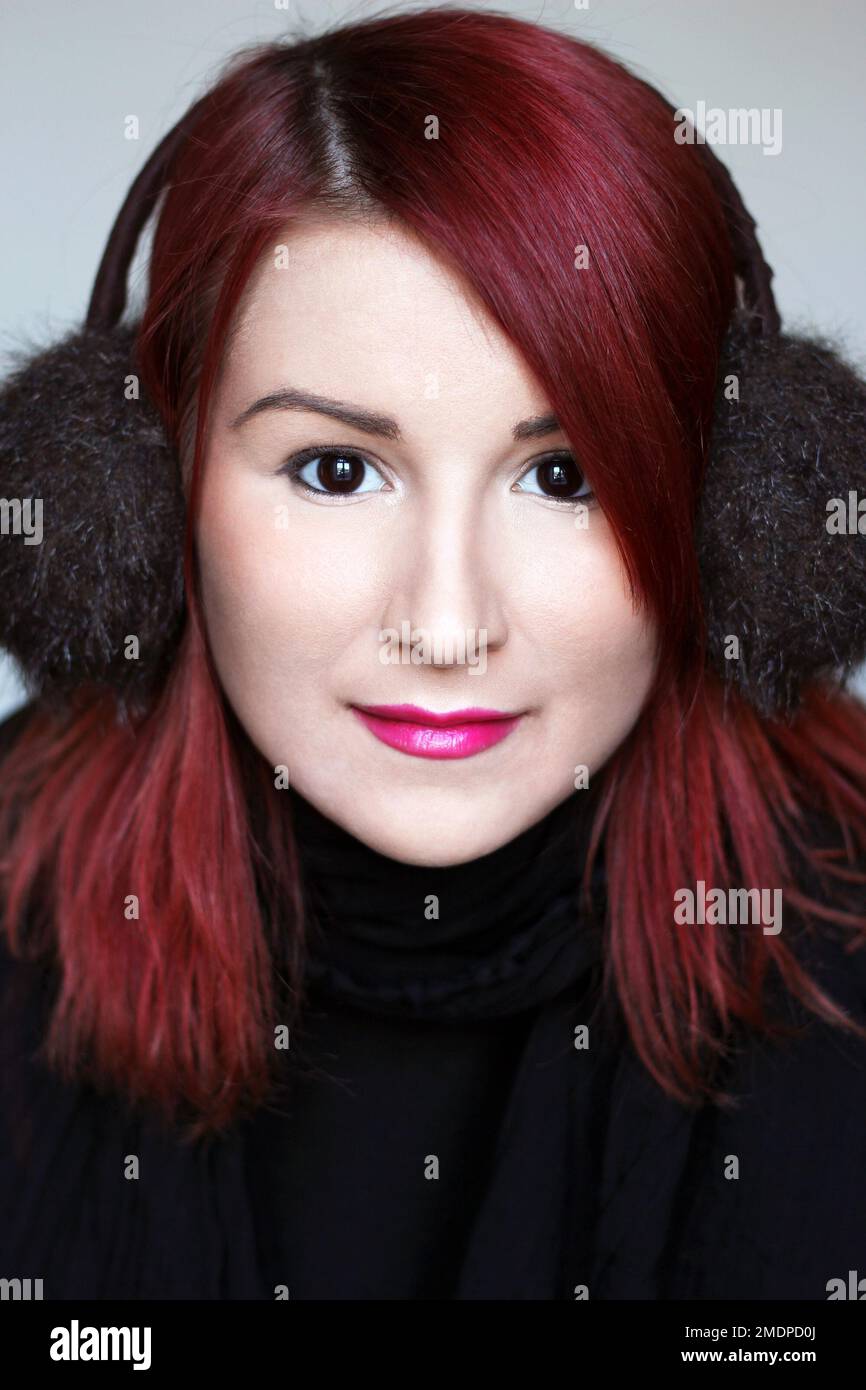 smiling redhead girl in the fur ear muffs and black scarf Stock Photo ...