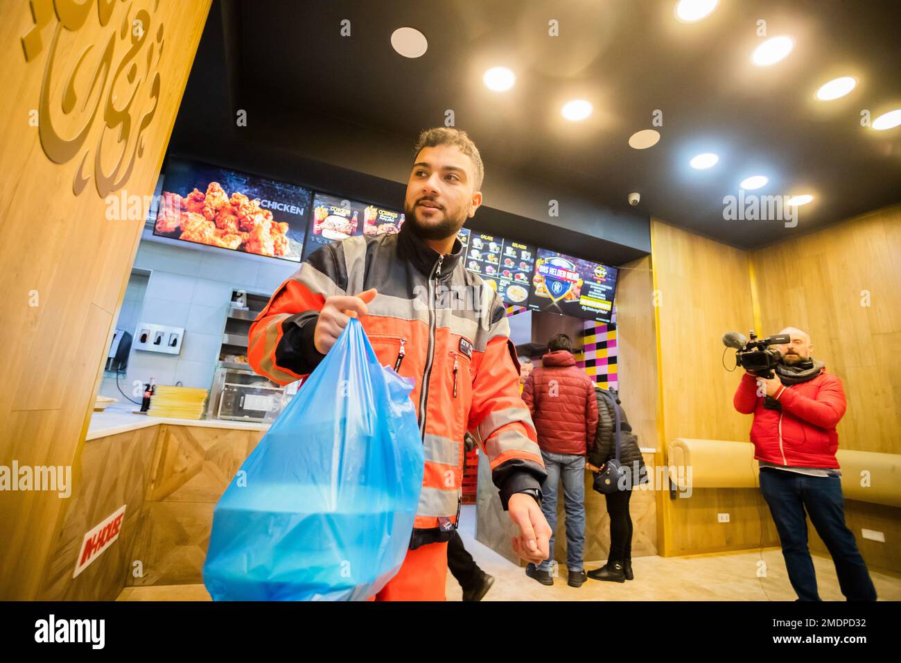 23 January 2023, Berlin: Paramedic Evren fetches food at the restaurant ...