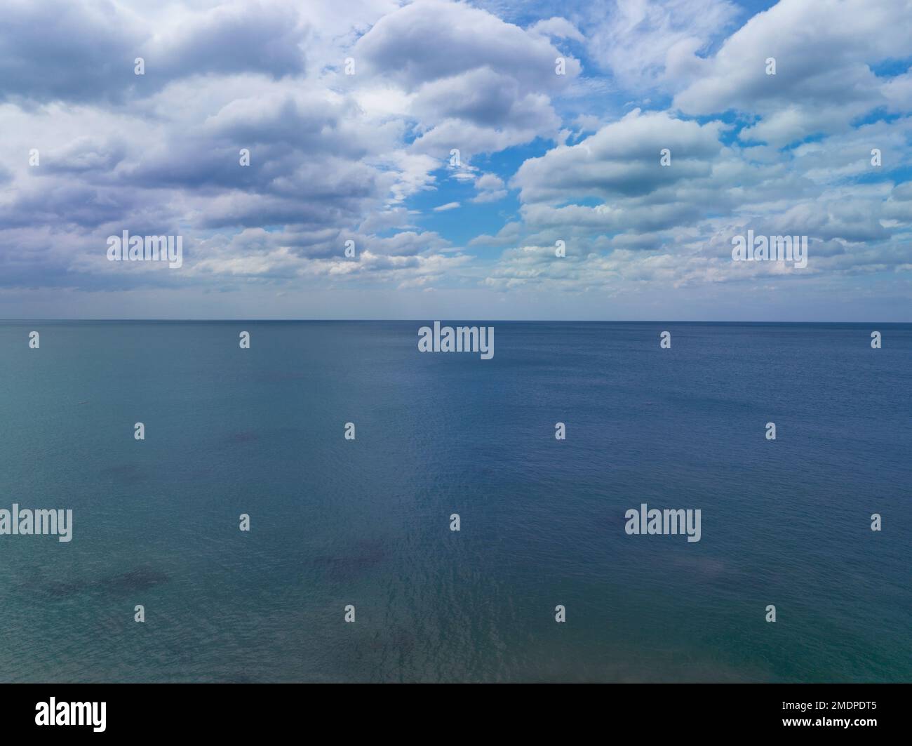 Aerial view of a blue sea surface water texture background and sun ...