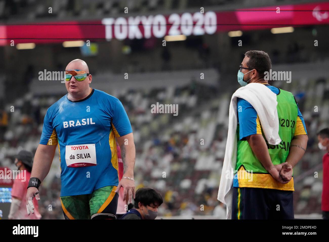 Alessandro Rodrigo da Silva of Brazil, left, walks near an assistant in ...