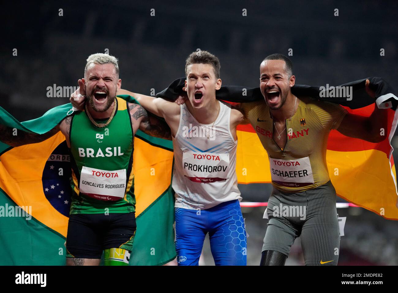 Anton Prokhorov of the Russian Paralympic Committee, center, pose for the media with with ...