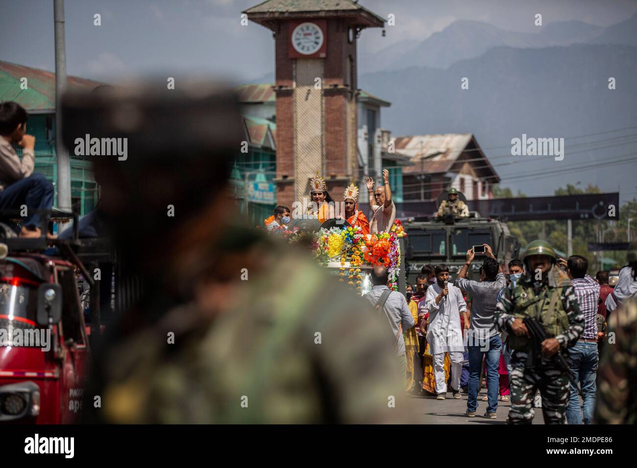 Indian paramilitary soldiers and policemen keep vigil as a small group of Kashmiri Hindus take ...
