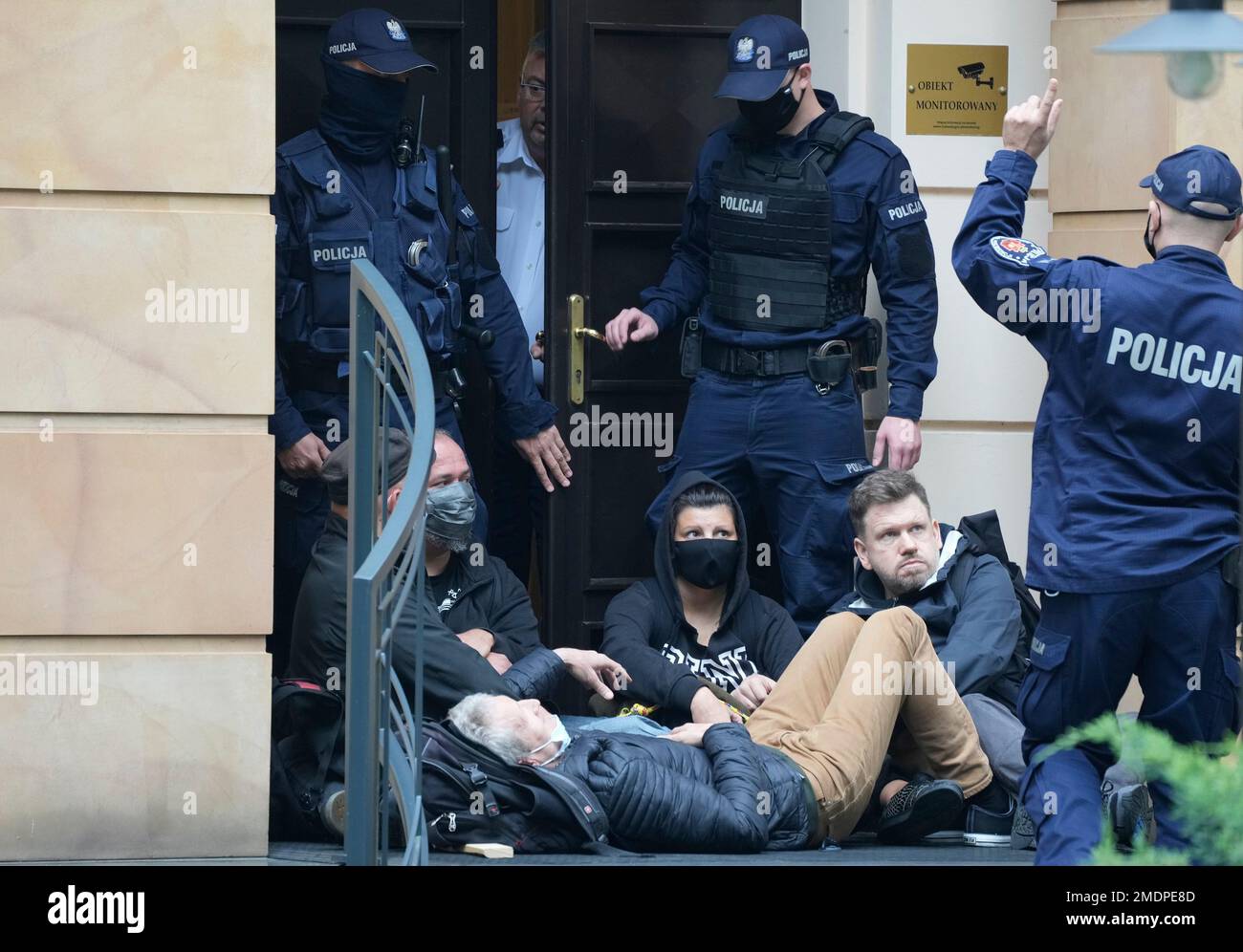 A group of pro-democracy activists in Poland seek to bloc the entrance ...