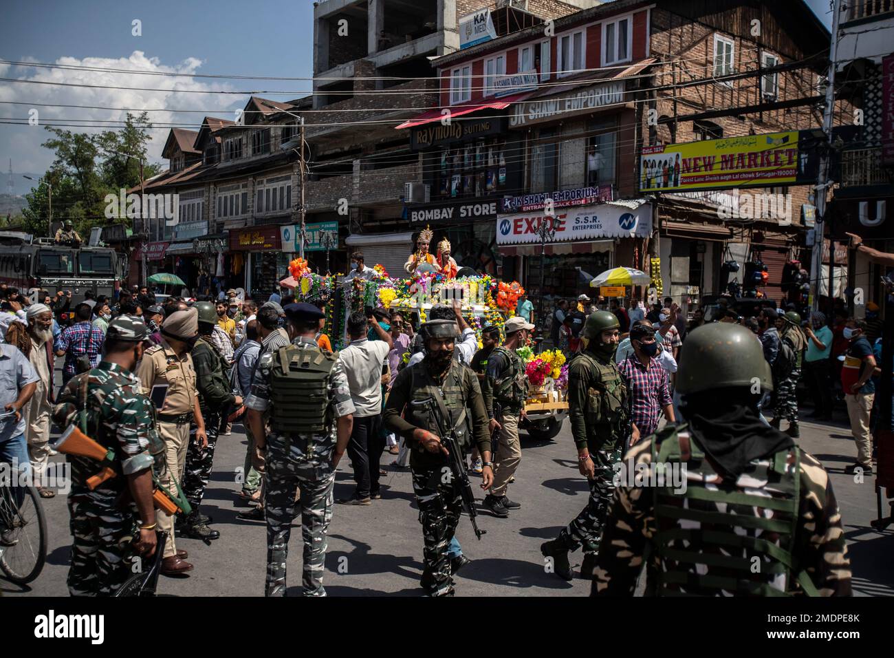 Indian paramilitary soldiers and policemen keep vigil as a small group of Kashmiri Hindus take ...