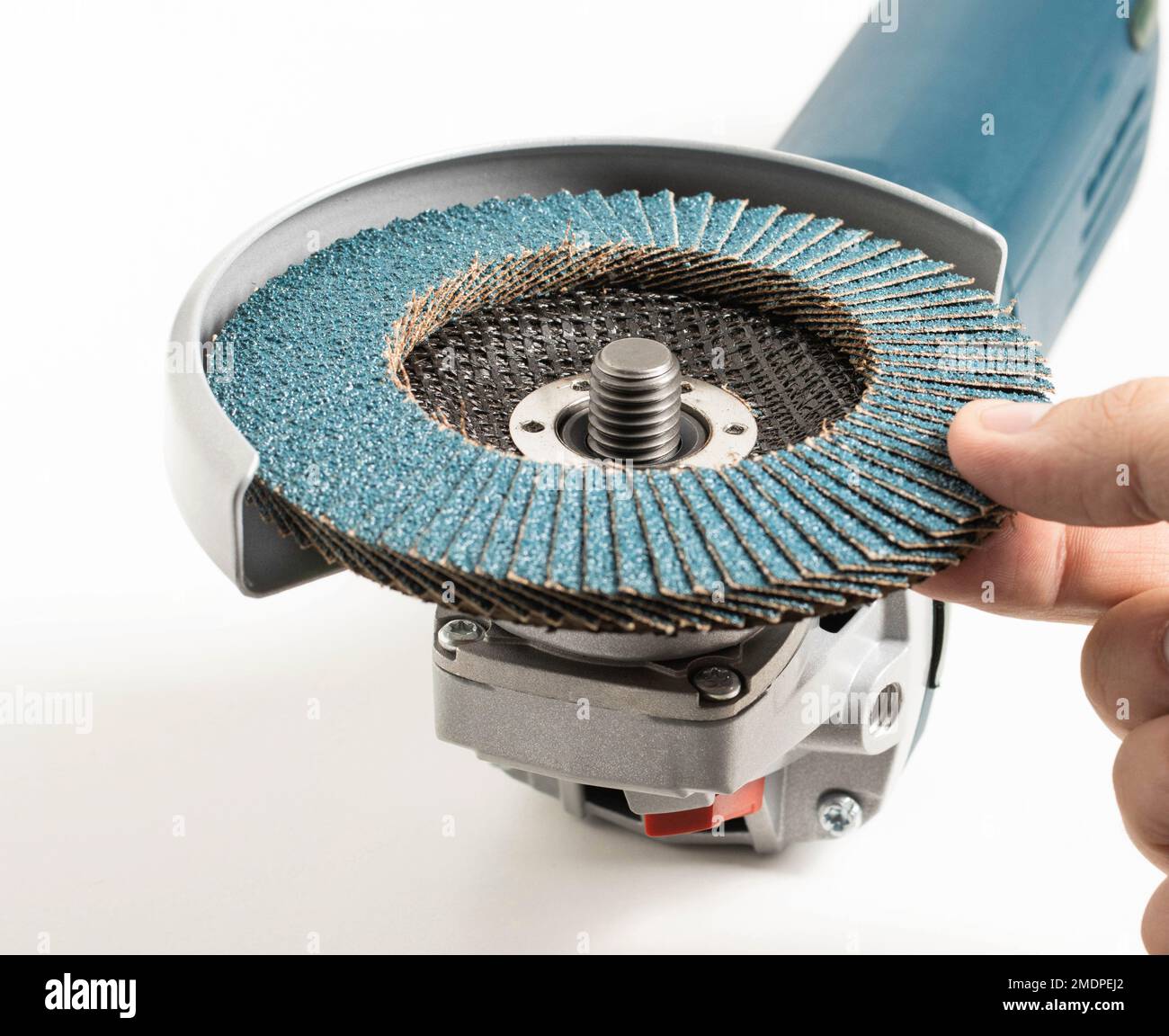 Installing a petal wheel on a grinder for processing wood surfaces Stock Photo - Alamy