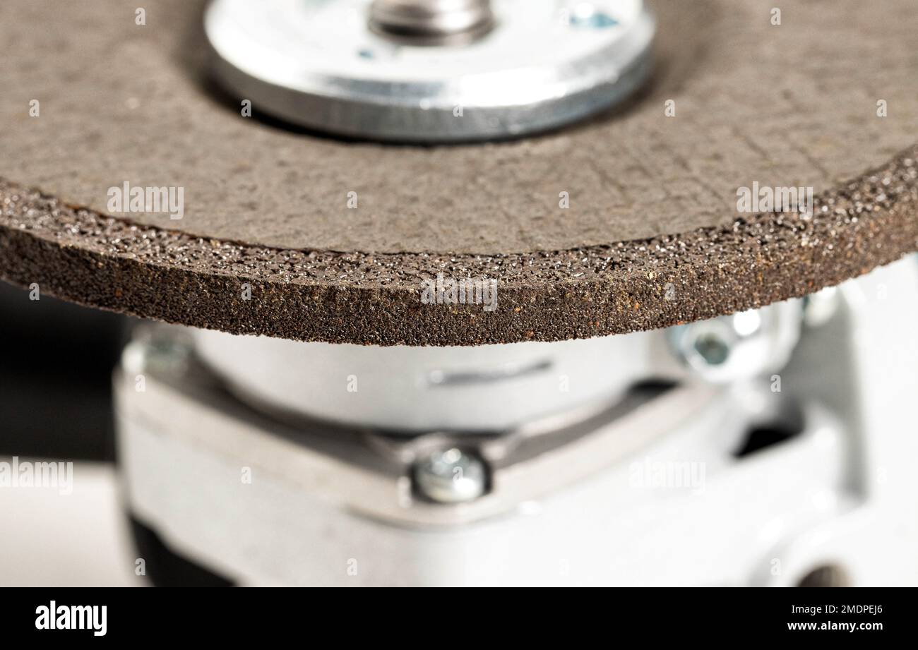 Cleaning reinforced circle on an angle grinder, close-up. Processing ...