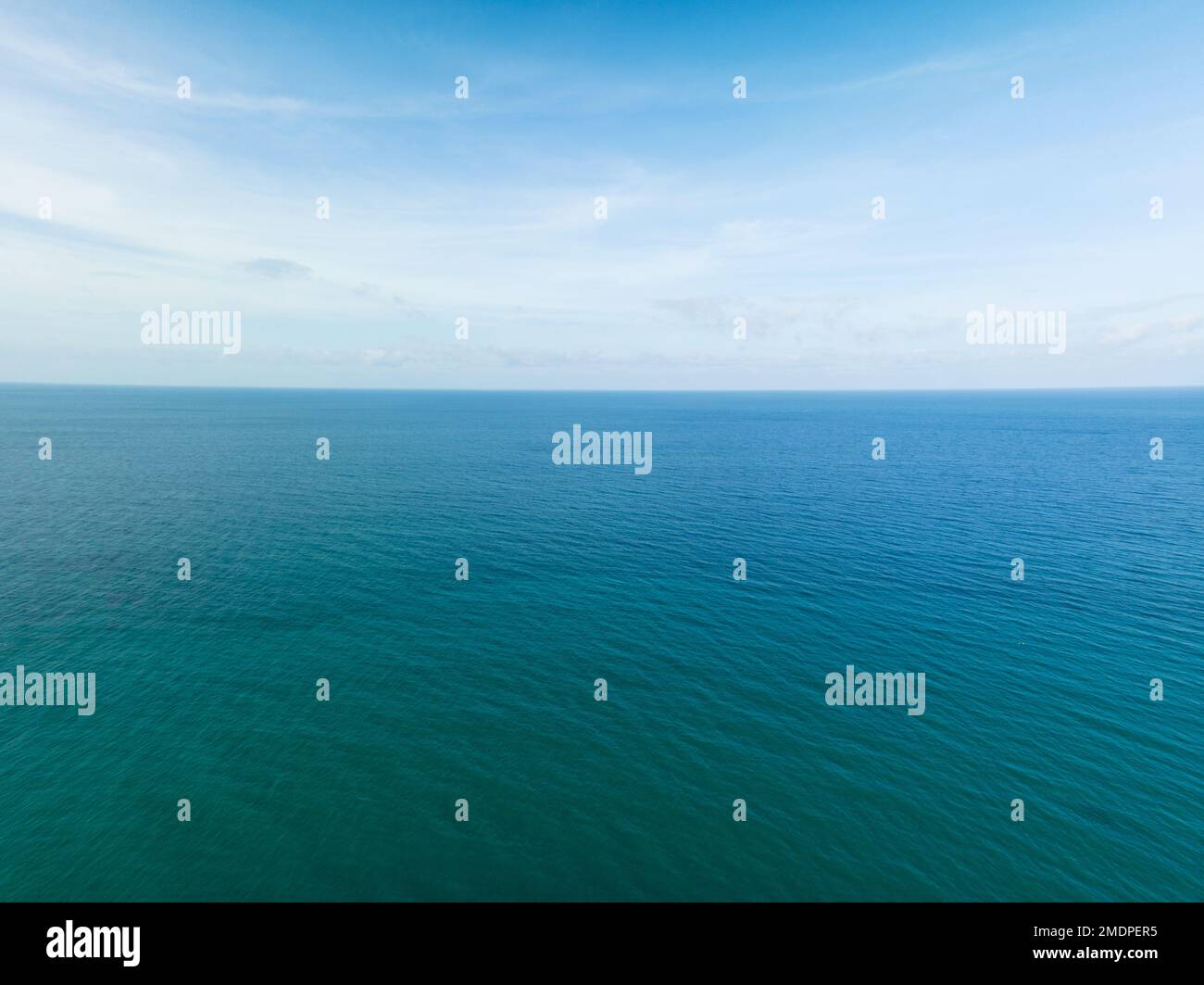 Aerial view of a blue sea surface water texture background and sun ...