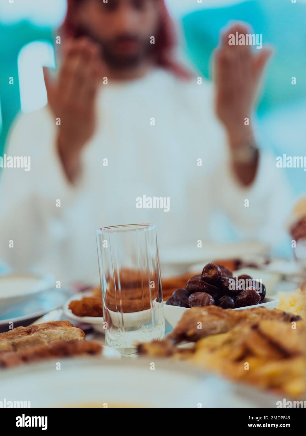 A Muslim family praying together, the Muslim prayer after breaking the ...