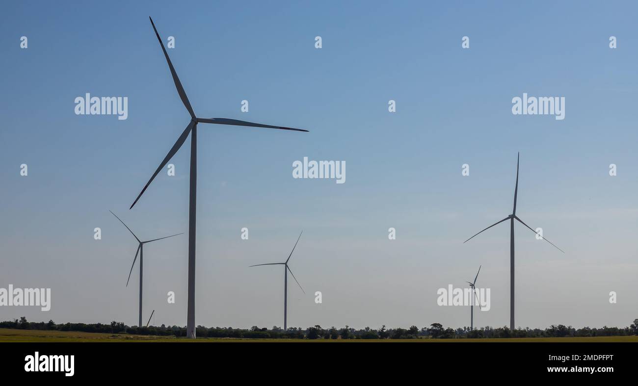 wind mill or also wind-turbine on wind farm in rotation to generate ...