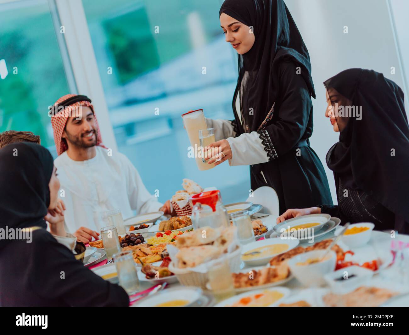 Eid Mubarak Muslim family having Iftar dinner drinking water to break ...