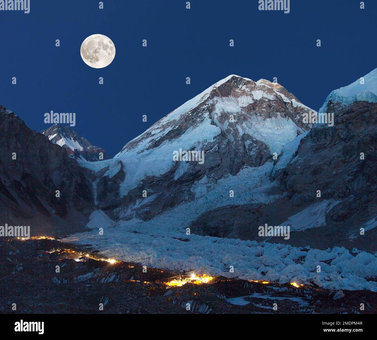 Night panoramic view of Mount Everest base camp with illuminated tents ...