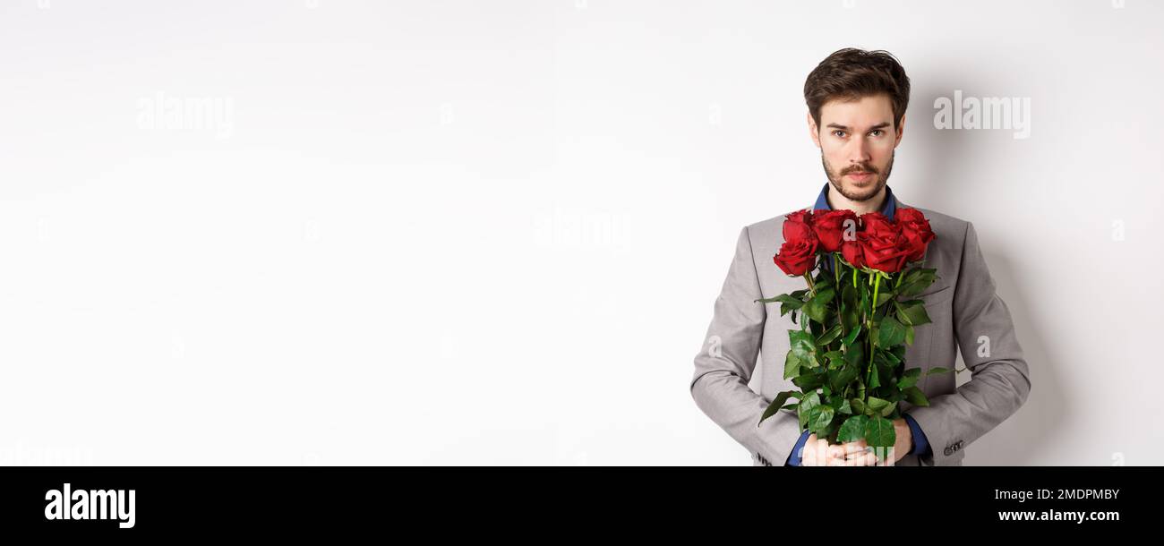 Valentines day and love concept. Confident and handsome man in suit ...