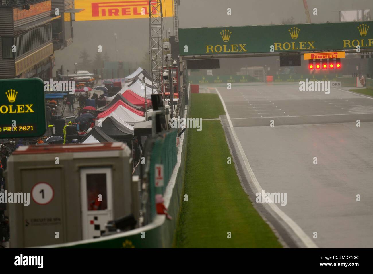 Drivers and cars wait under tents during a rain delay at the Formula ...