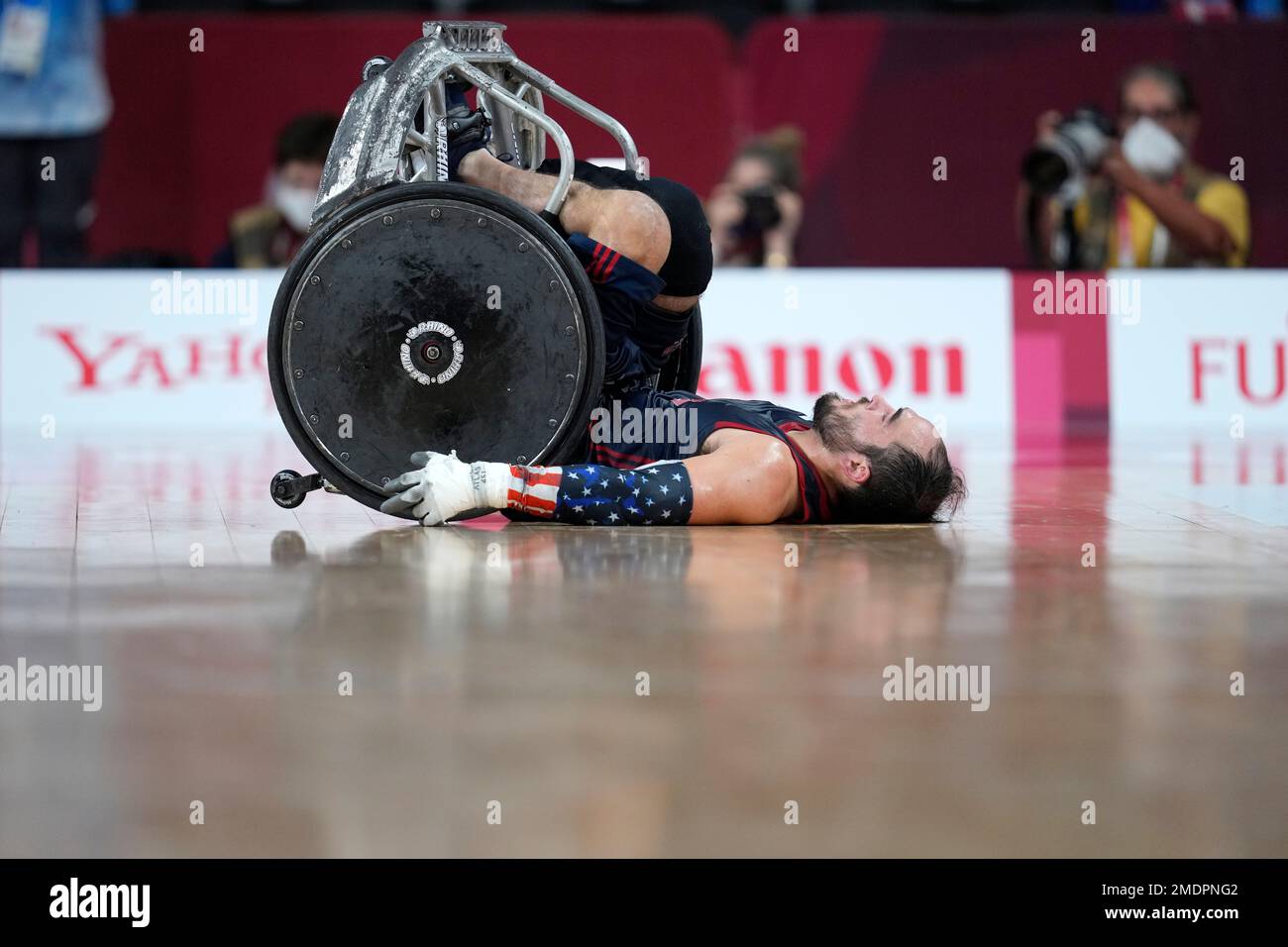 Charles Aoki of the United States lies on the field after a fall during ...