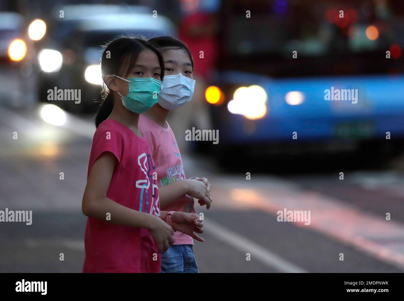 Two Taiwanese girls wear face masks to protect against the spread of ...