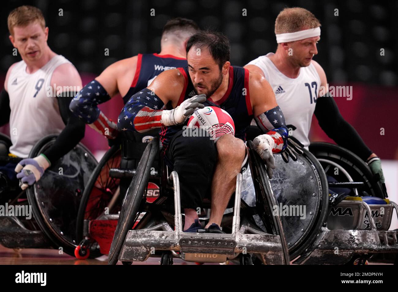 Charles Aoki of the United States holds the ball during the wheelchair ...