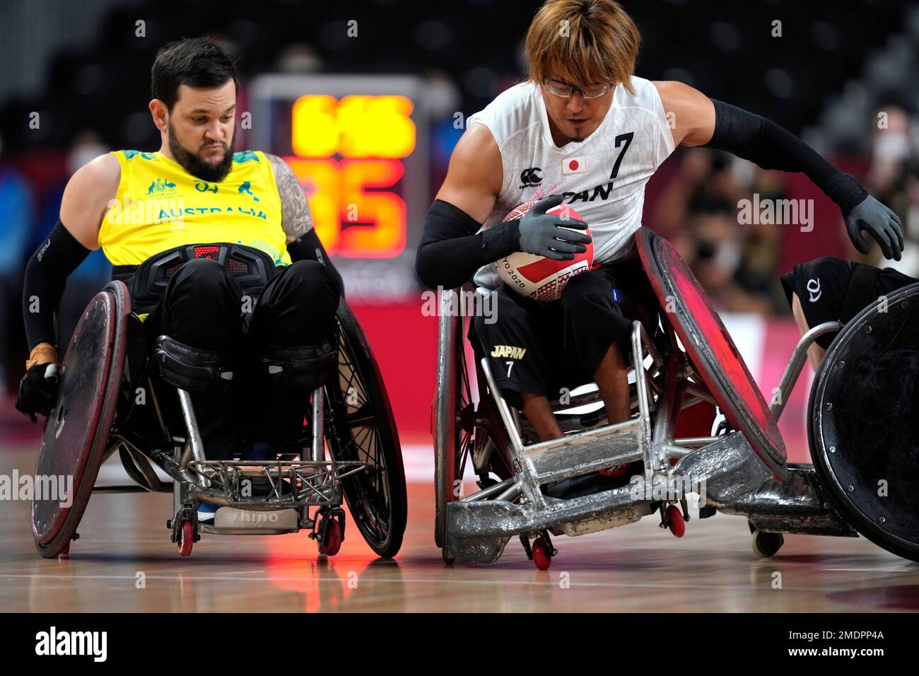 Japan's Daisuke Ikezaki, right, moves the ball against Australia's Jake ...