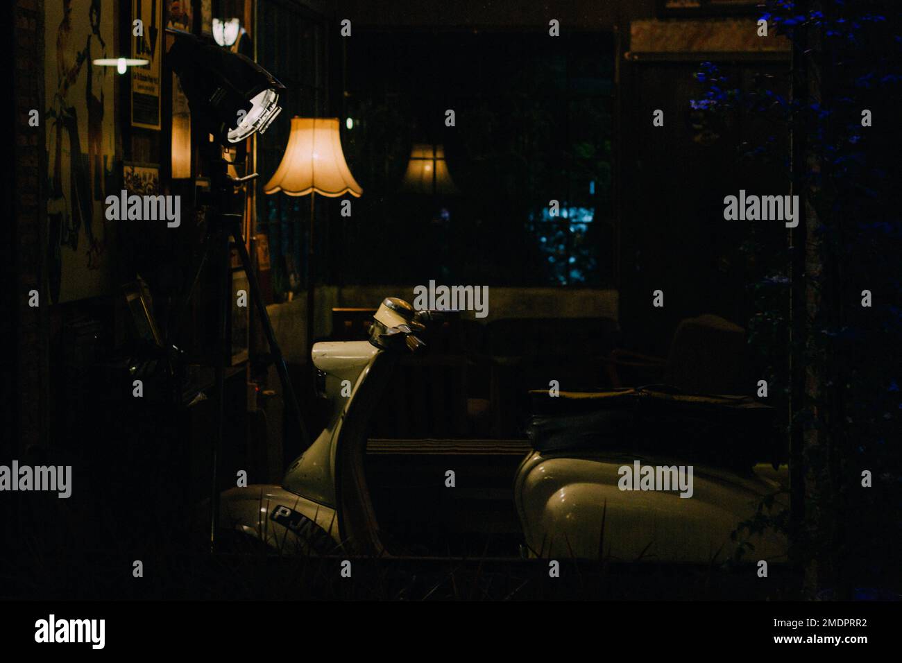 A retro motorbike in the dark vintage-style room Stock Photo - Alamy