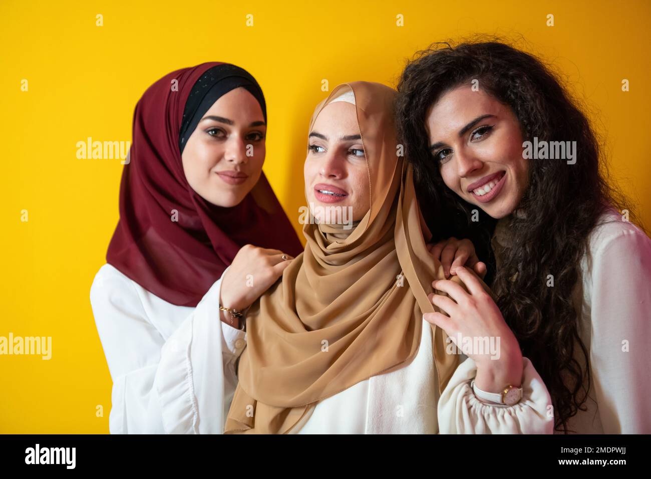 Group portrait of beautiful Muslim women two of them in a fashionable ...
