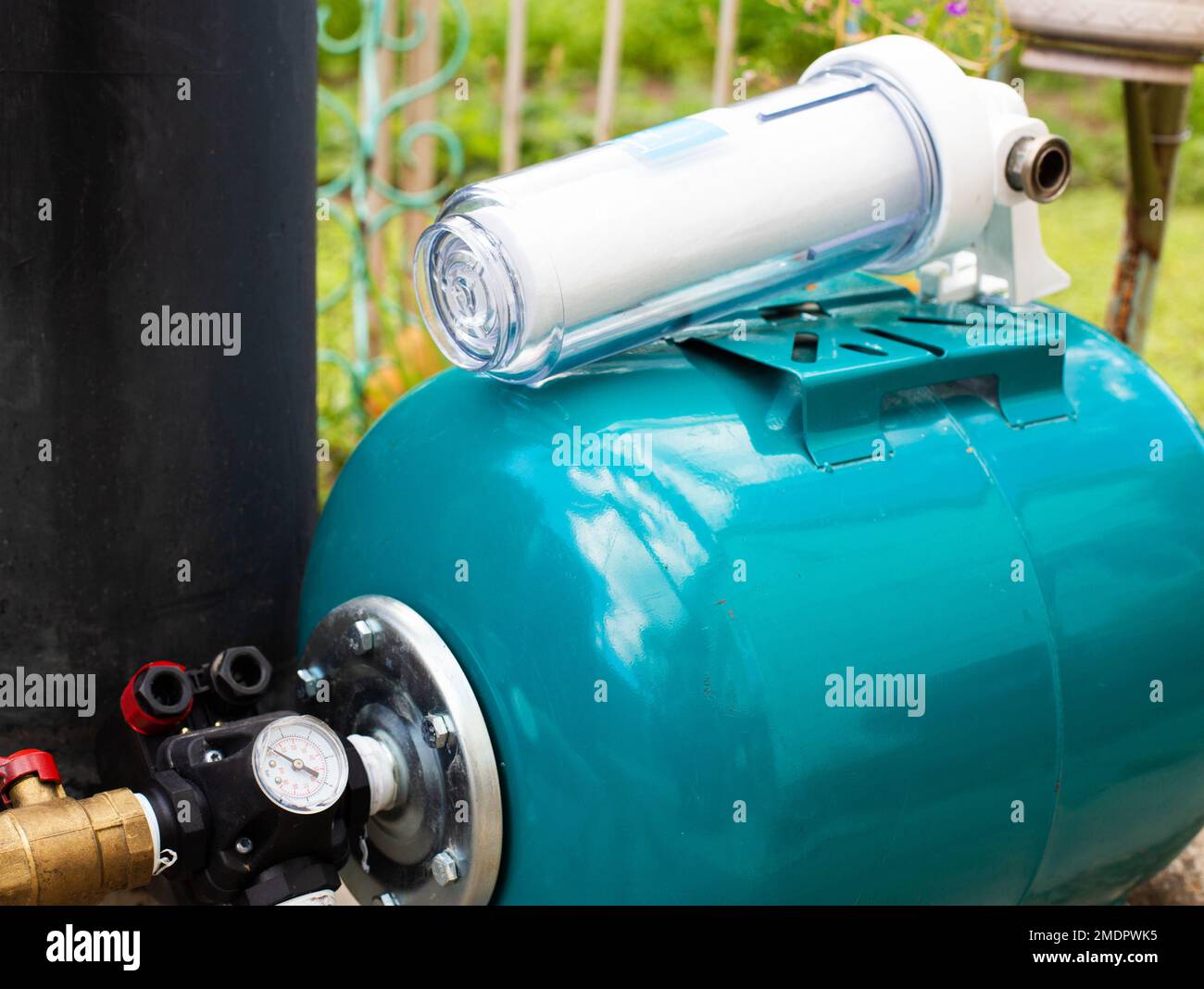 Filtration of water from a well with a sand and dirt filter. Water ...