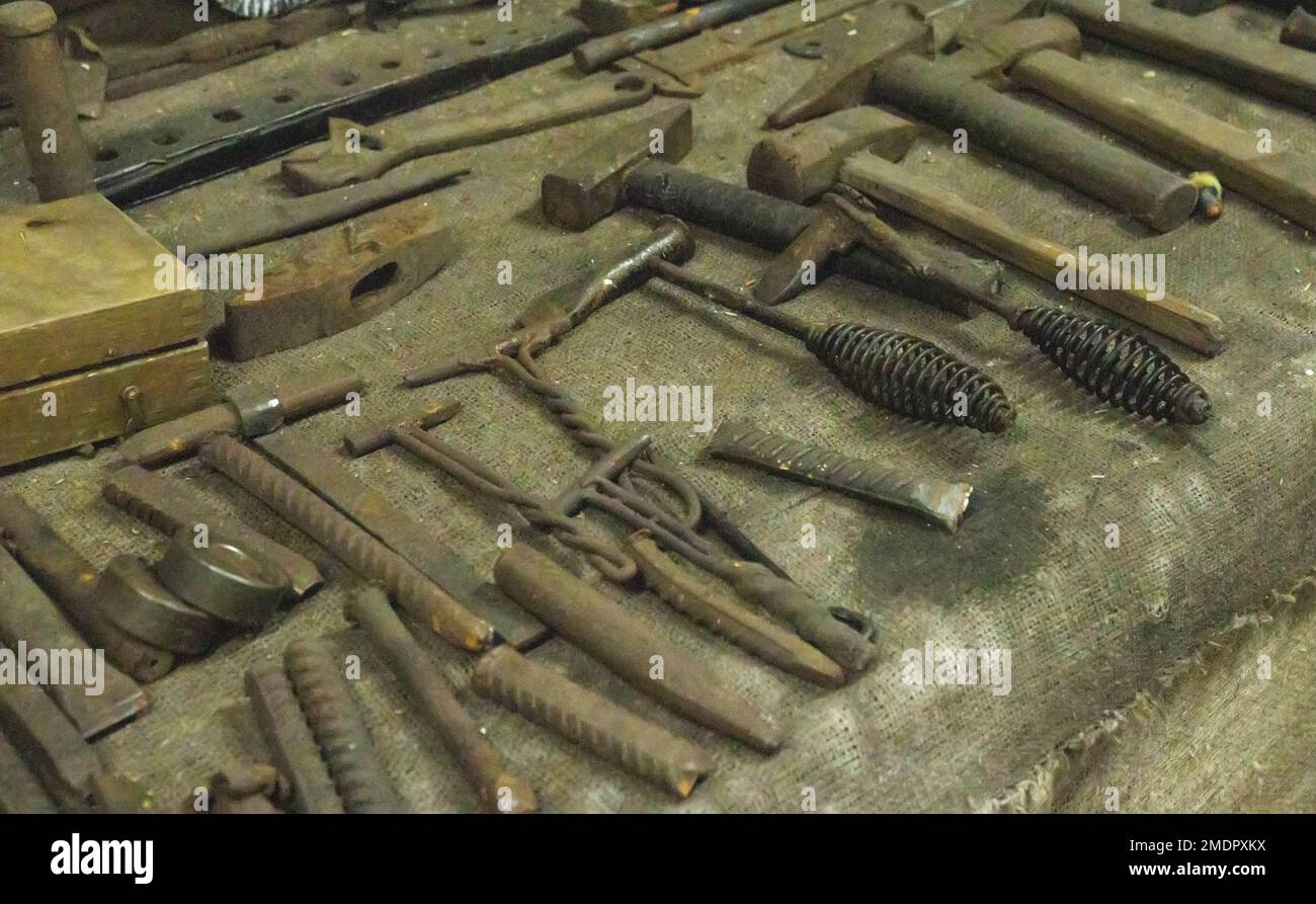 Lots of metal tools to work in the forge. Background, industry ...