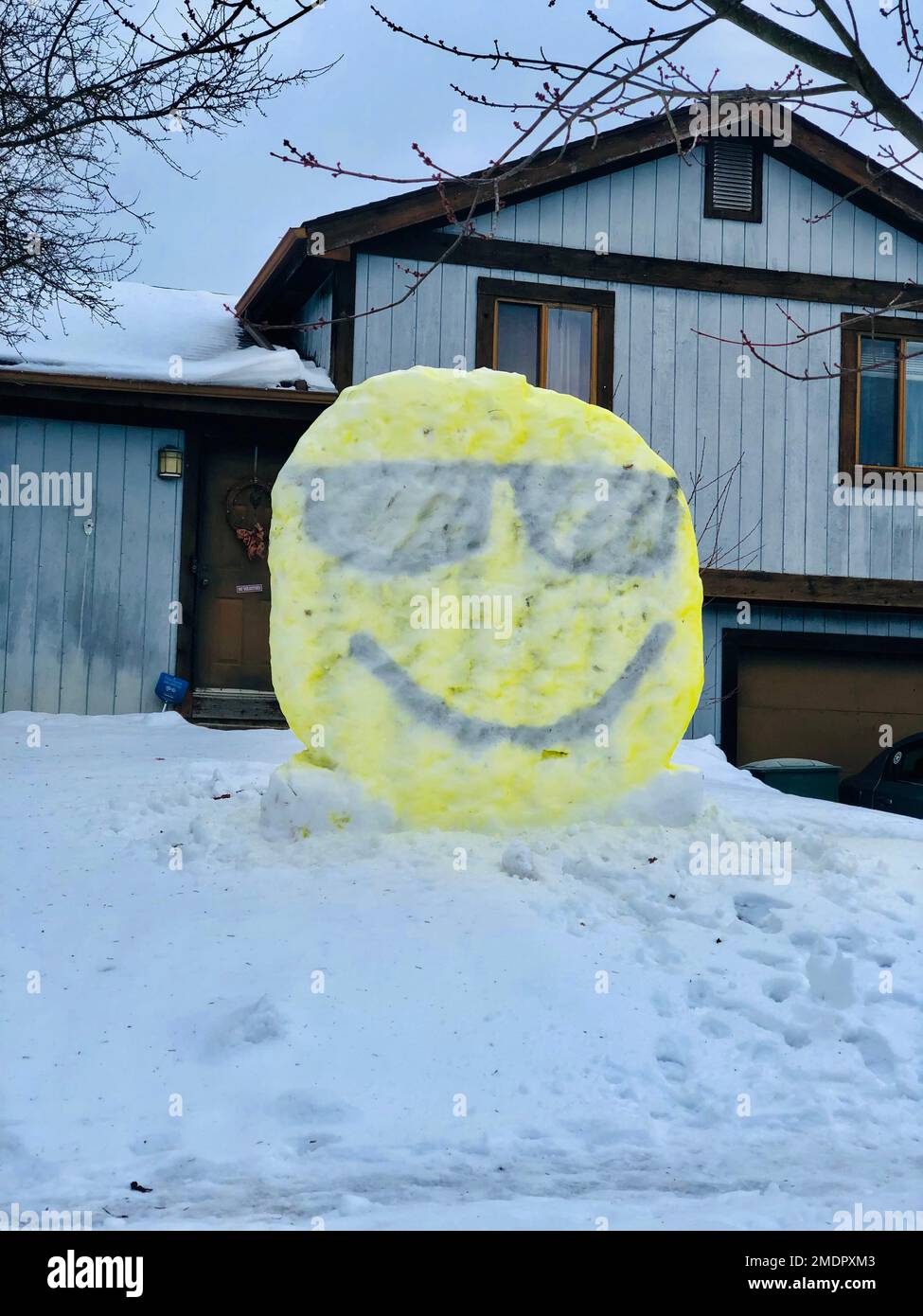 A smiley face on big snowball in the house yard Stock Photo - Alamy