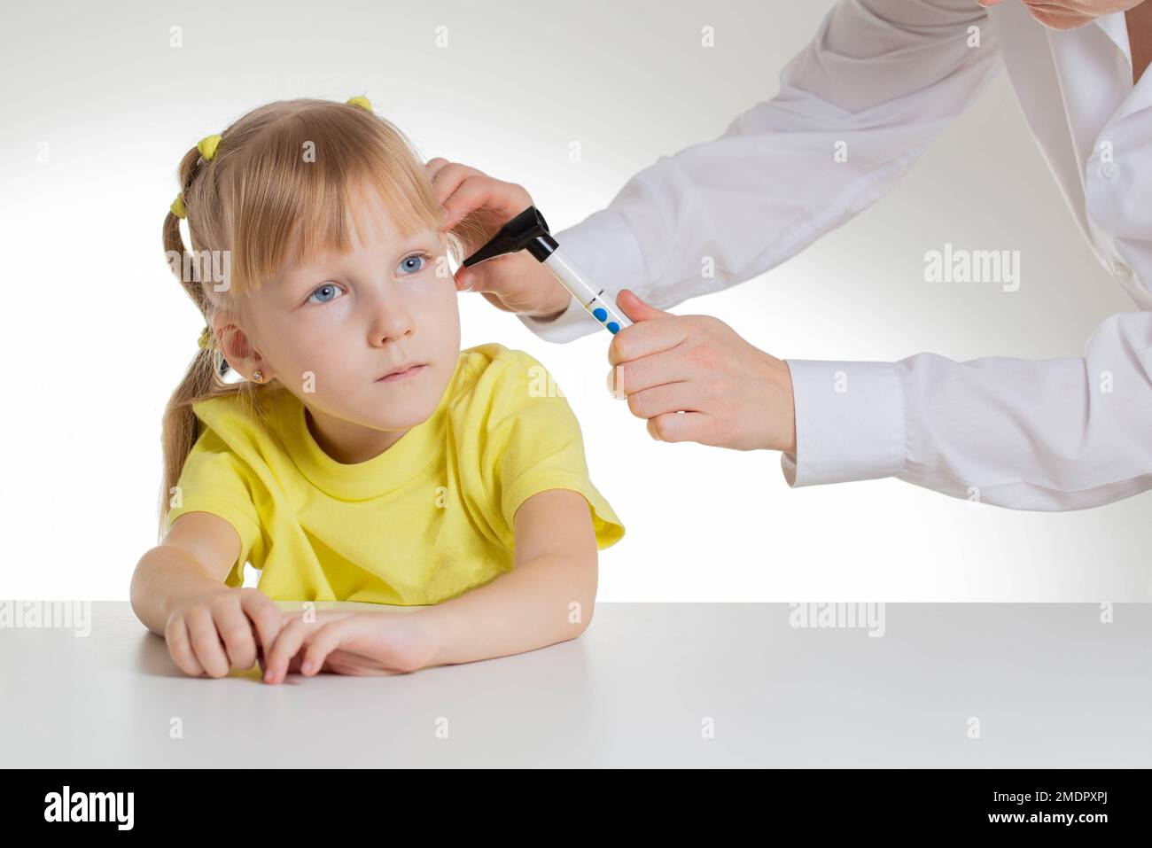 Doctor ENT doctor looks into the ear of a beautiful girl patient at the ...