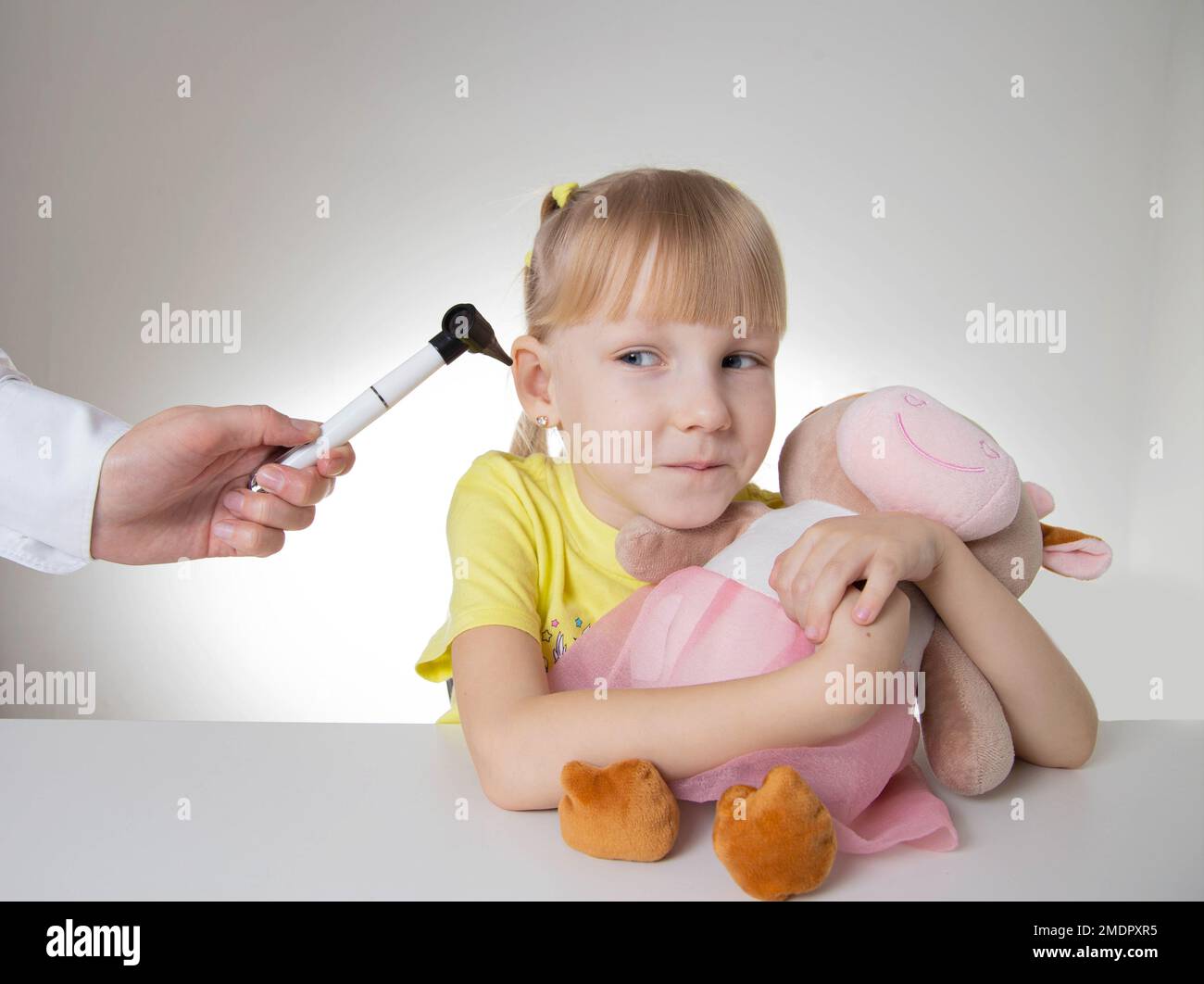 Doctor ENT doctor looks into the ear of a beautiful girl patient at the ...